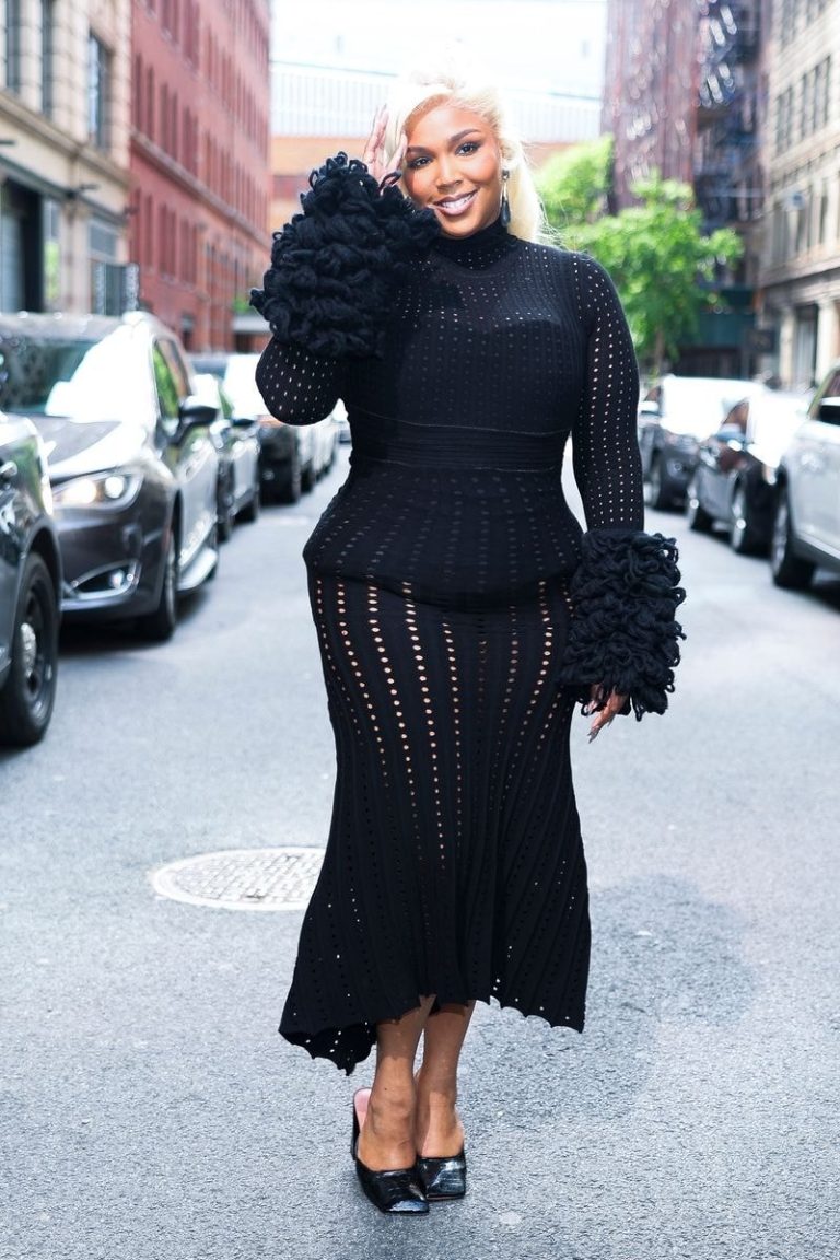 Lizzo owns the red carpet in a skin-tight pink look as she proudly ...